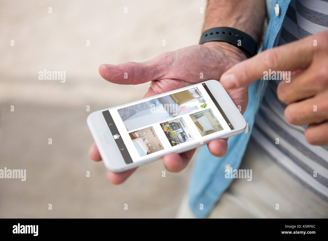 Interior of house on mobile screen against midsection of man using ...