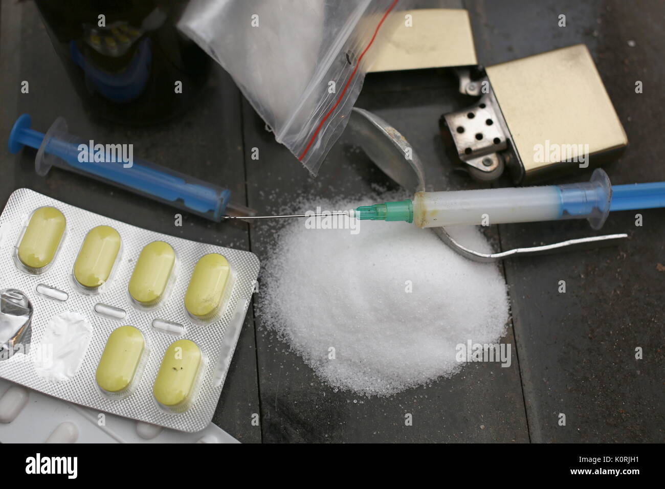 Hard drugs on dark table. A dark theme, drug use. Preparation of drugs ...
