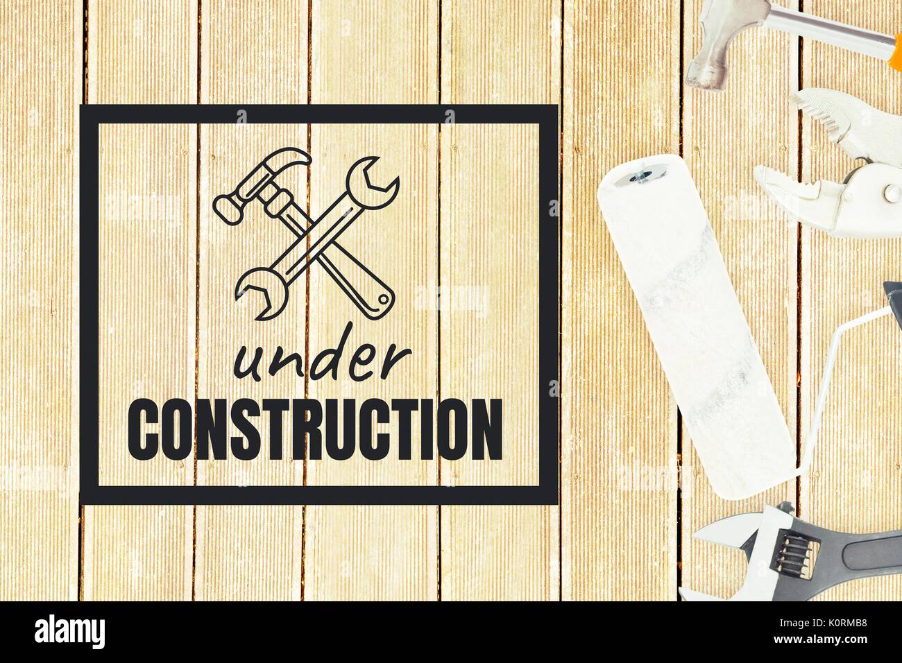 Digital composite of Under construction text against tools photo Stock ...