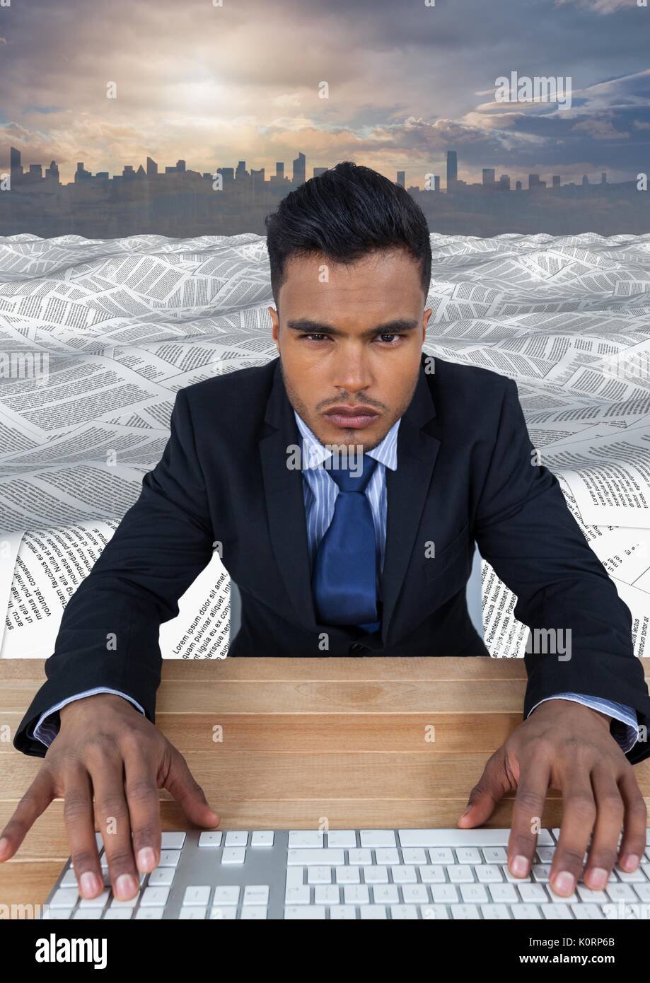 Digital composite of Businessman using keyboard in sea of documents ...