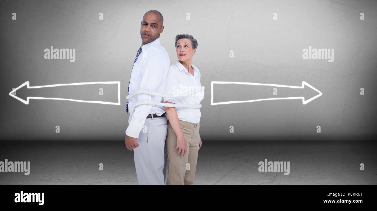 Business people standing back to back against grey room Stock Photo - Alamy