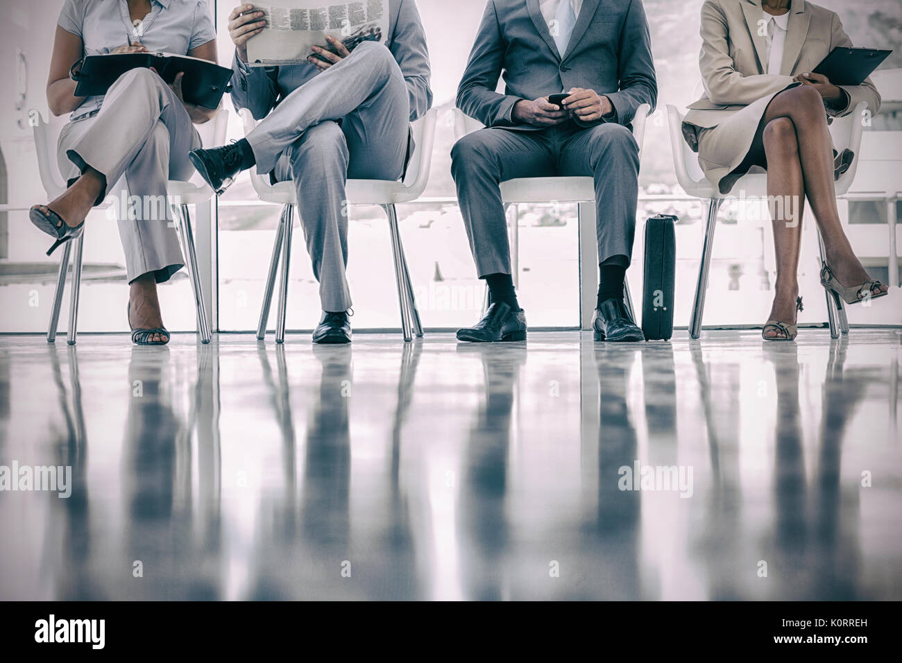 Group of well dressed business people waiting in waiting room Stock ...