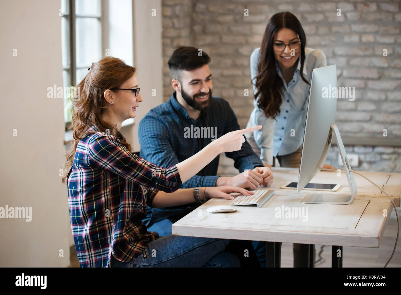 Group of young designers working as team Stock Photo - Alamy