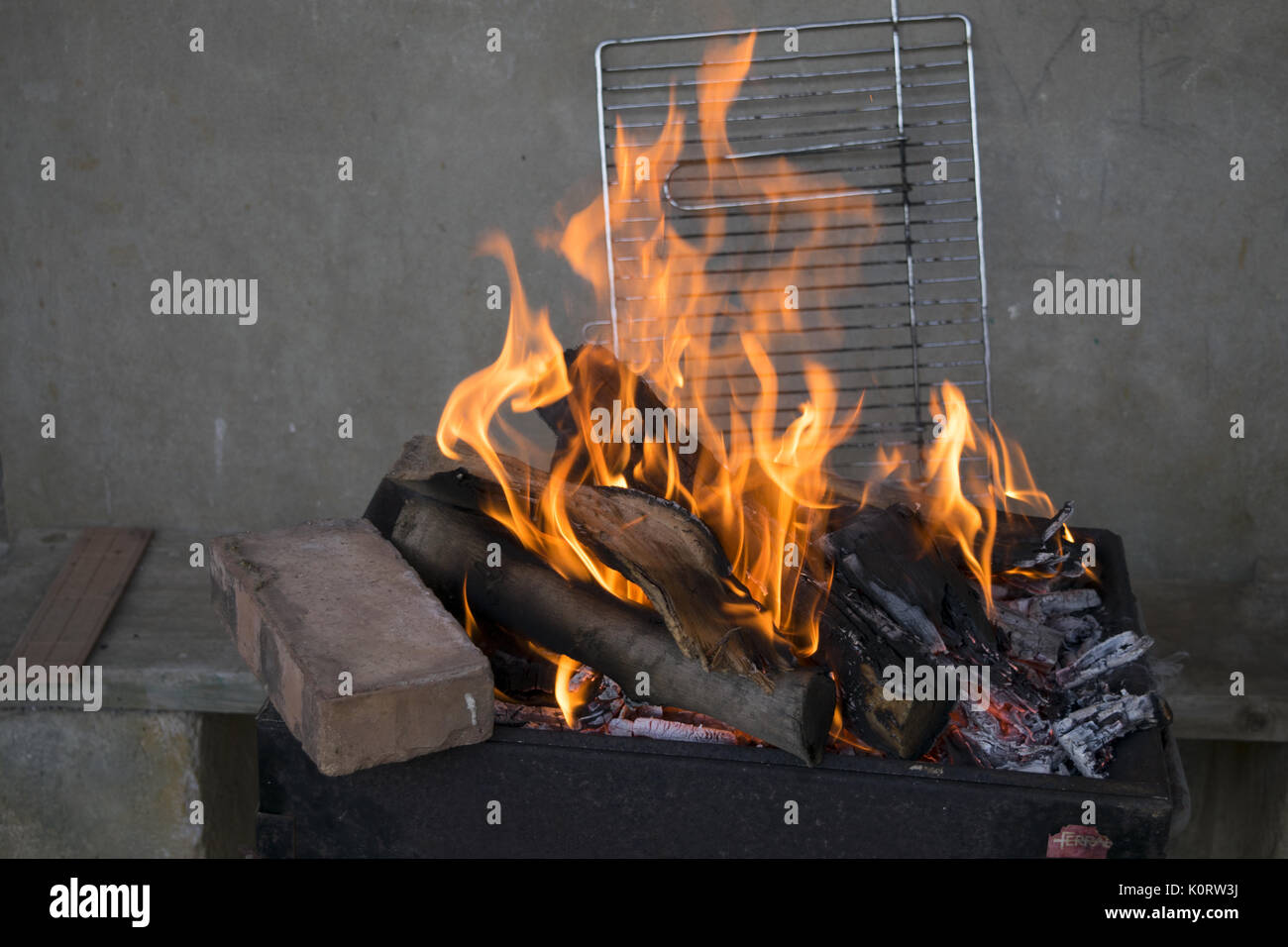preparing fire in the barbecue with wood Stock Photo - Alamy