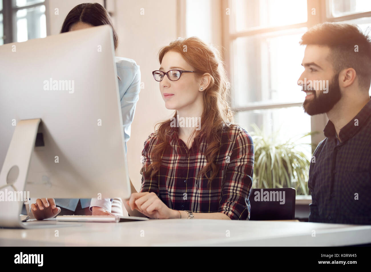 Group of young designers working as team Stock Photo - Alamy