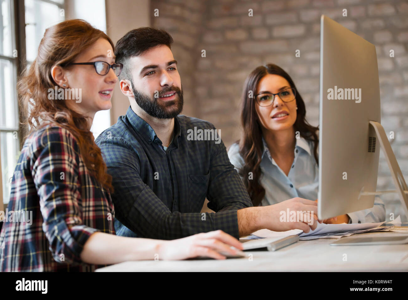 Group of young designers working as team Stock Photo - Alamy