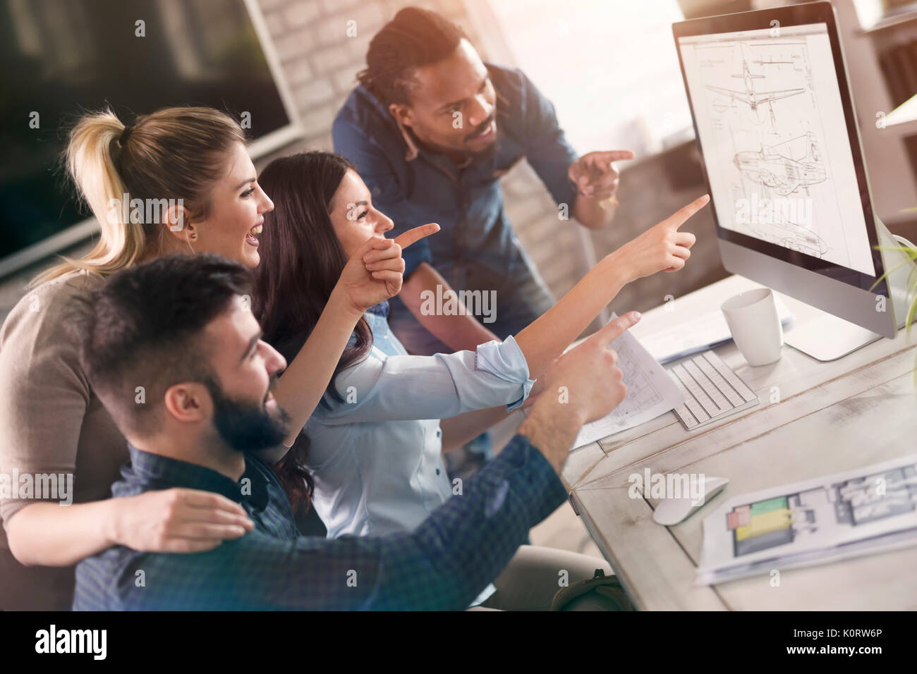 Group of young designers working as team Stock Photo - Alamy