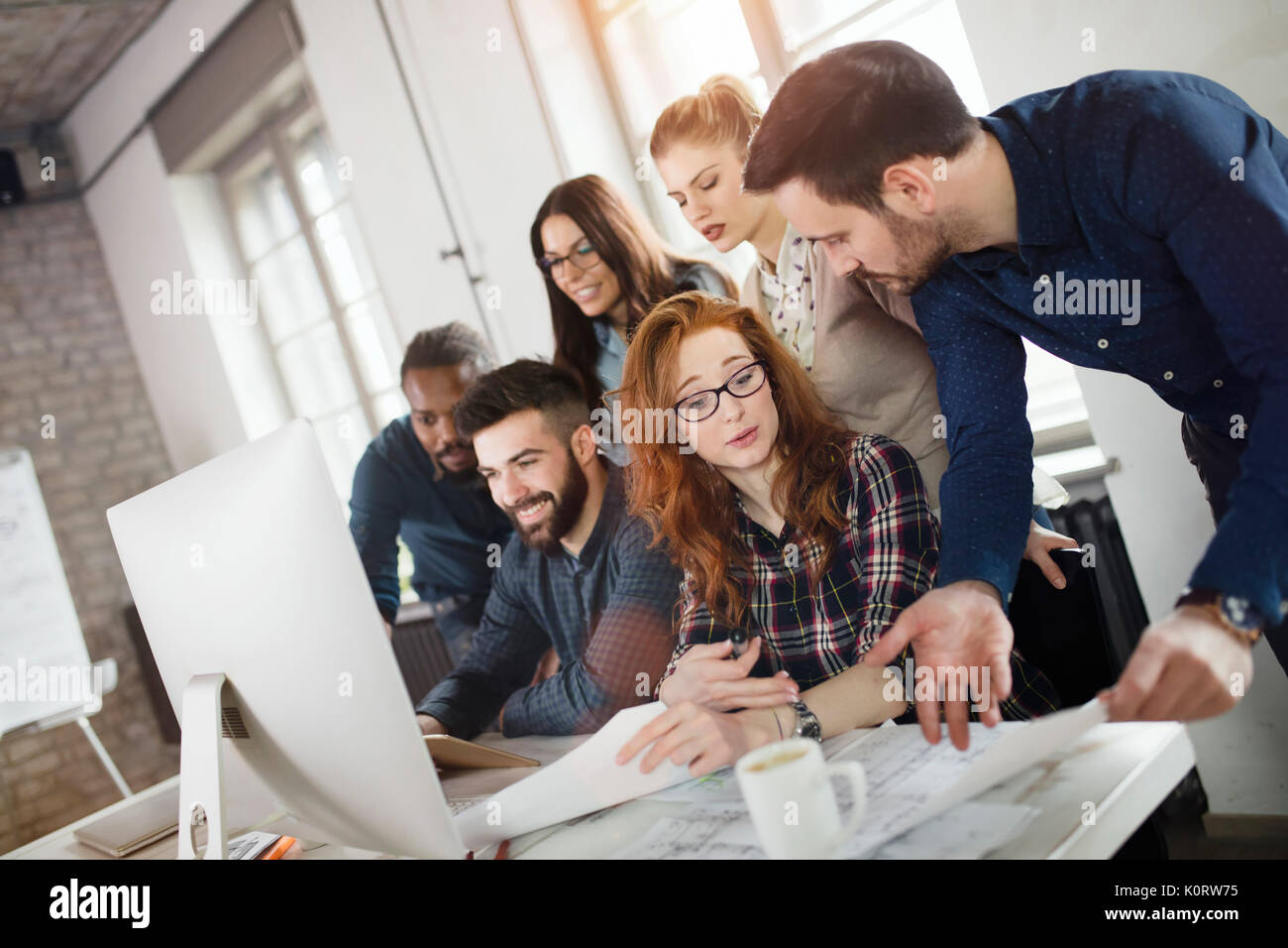 Group of young designers working as team Stock Photo - Alamy
