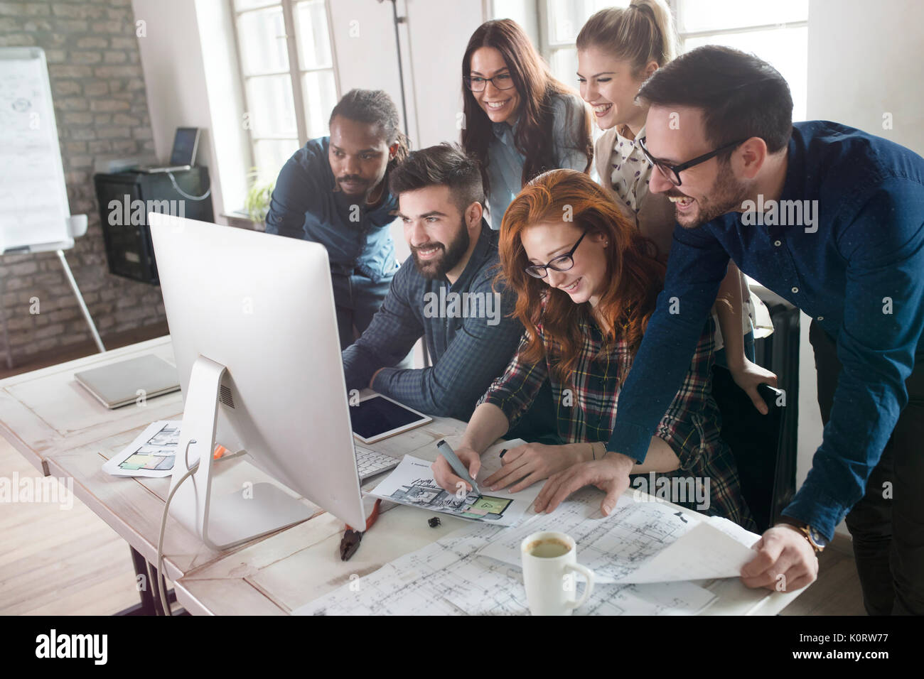 Group of young designers working as team Stock Photo - Alamy