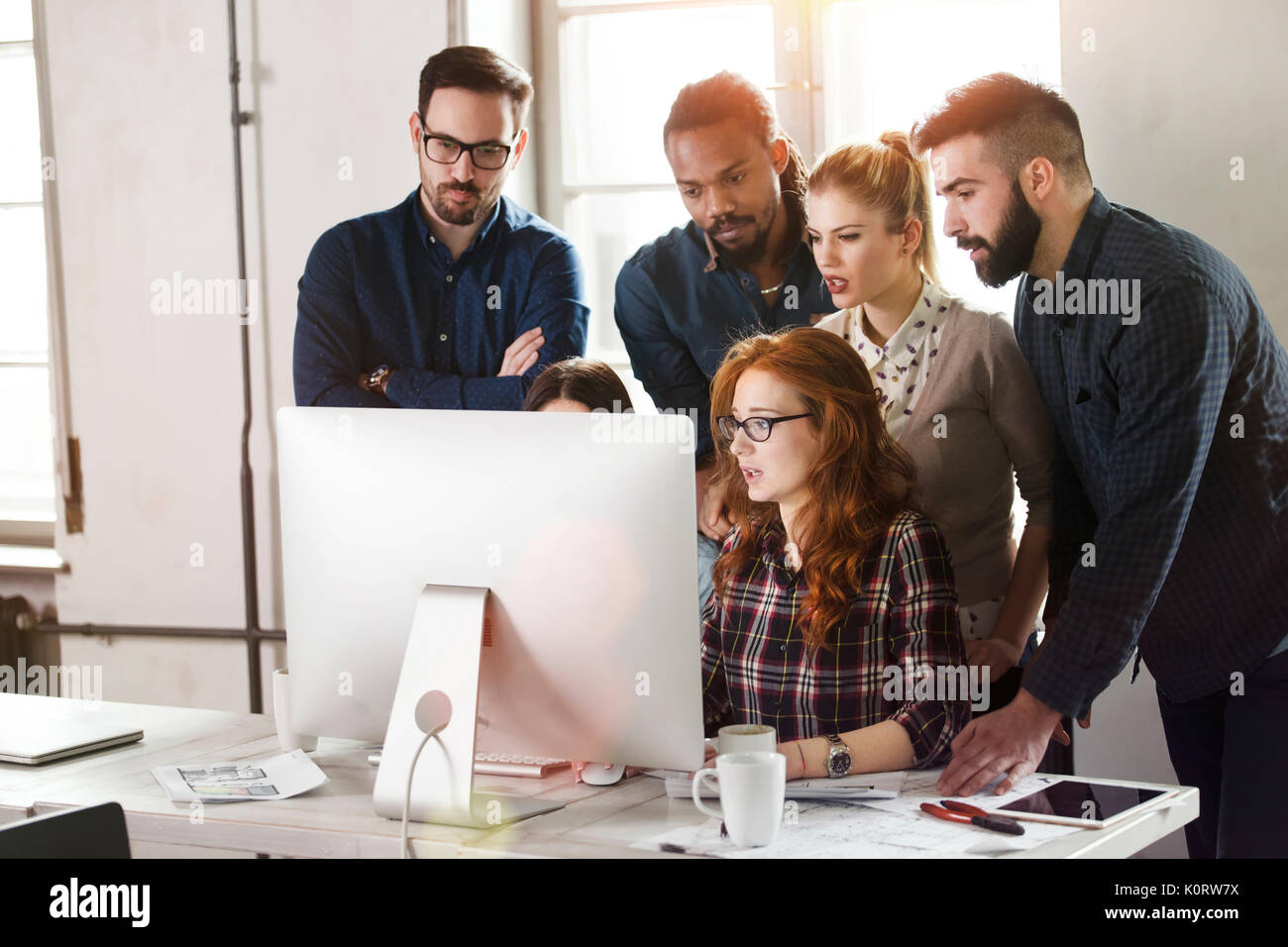 Group of young designers working as team Stock Photo - Alamy