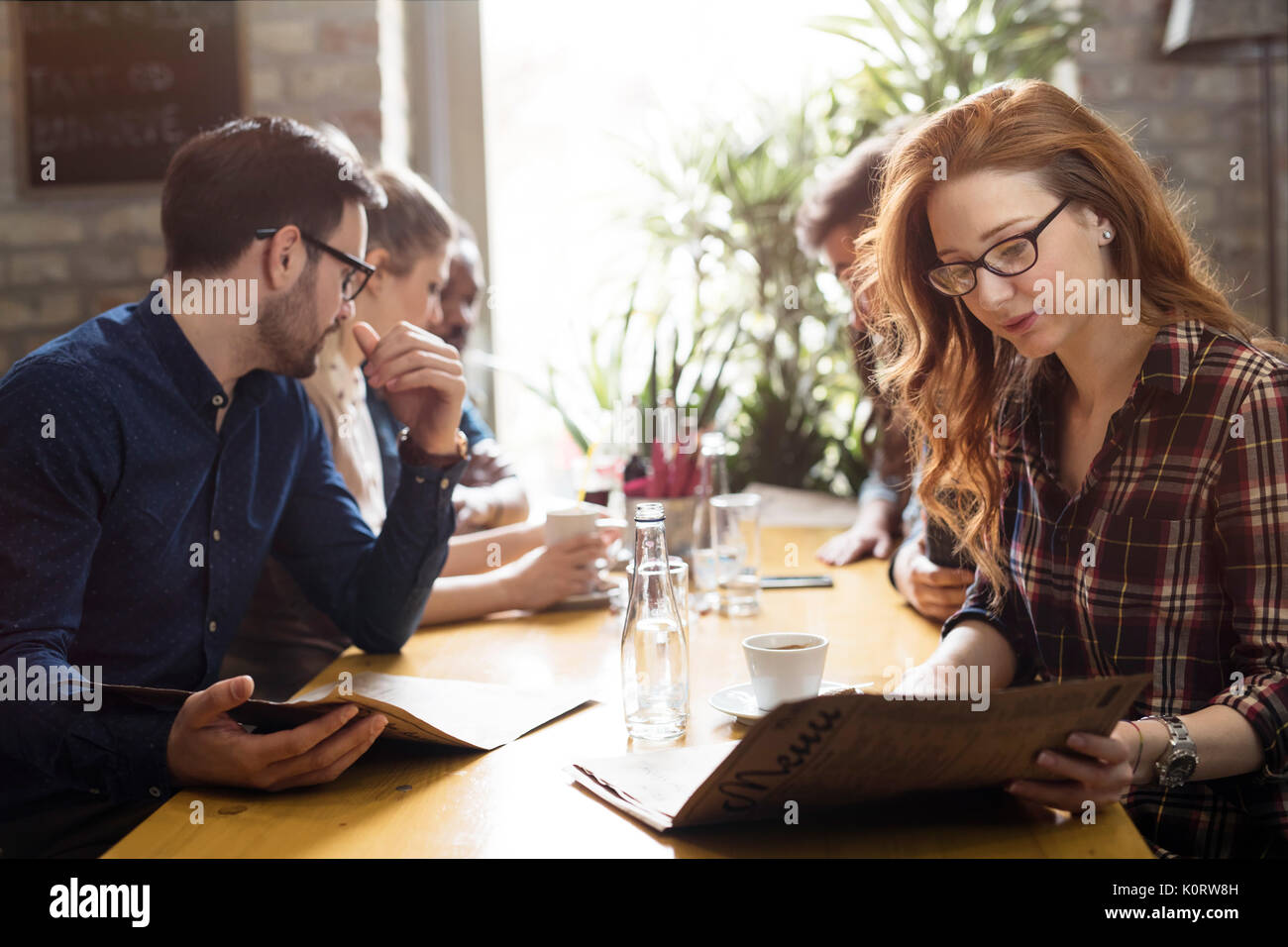 Happy colleagues from work socializing in restaurant Stock Photo - Alamy