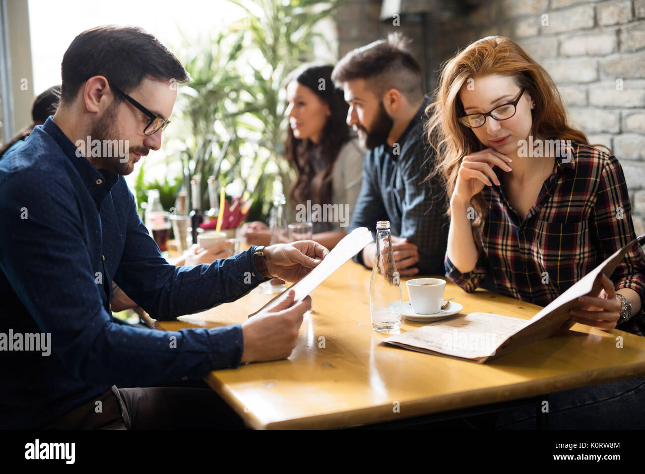 Happy colleagues from work socializing in restaurant Stock Photo - Alamy