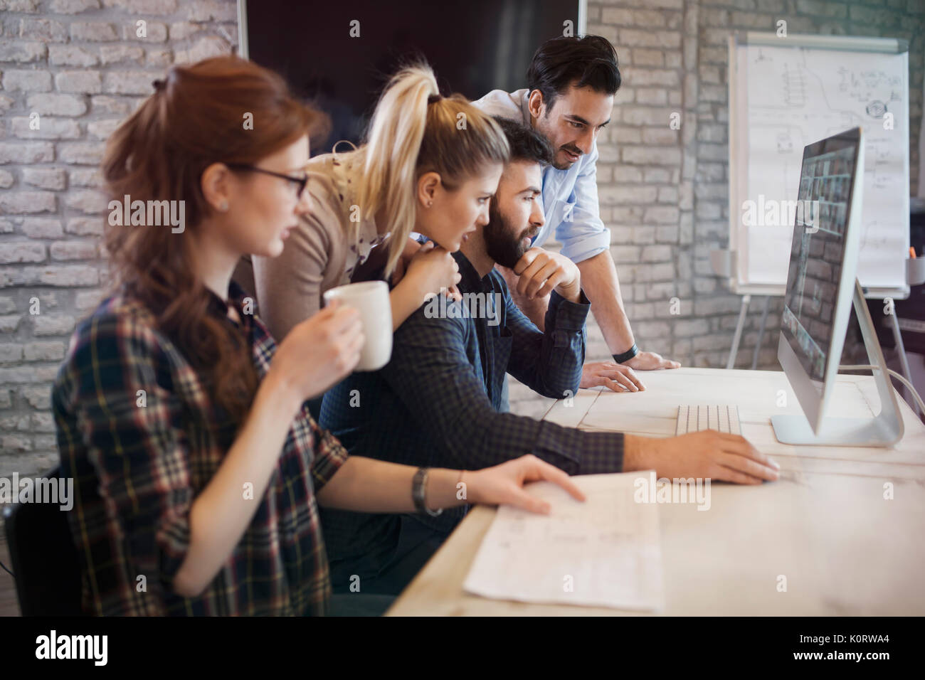 Group of young designers working as team Stock Photo - Alamy