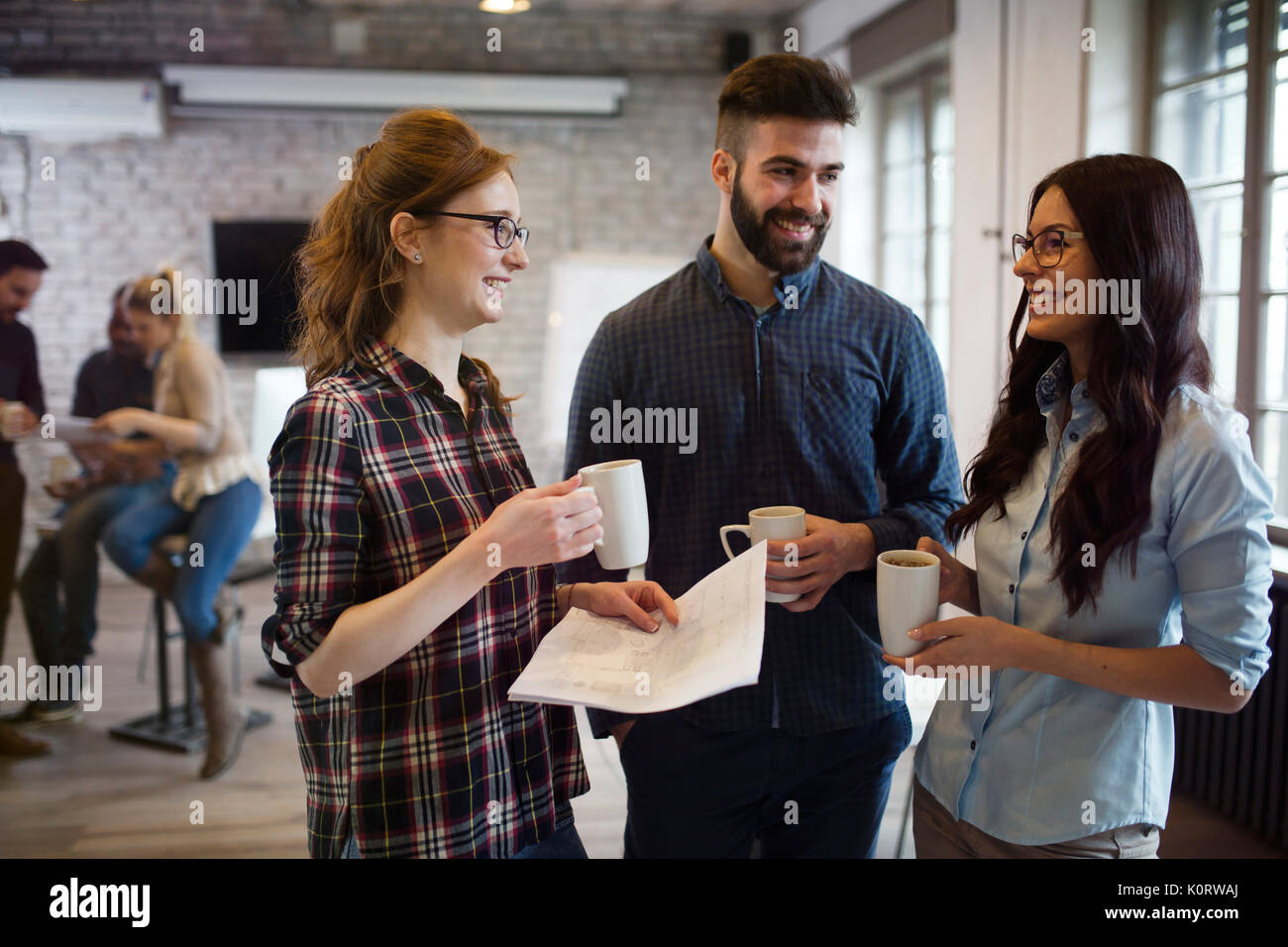 Picture of group of young perspective designers discussing Stock Photo ...