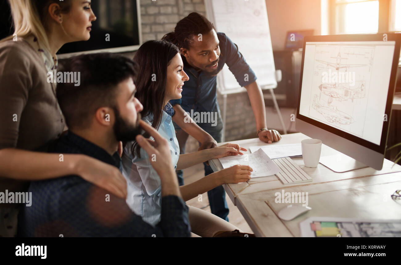 Group of young designers working as team Stock Photo - Alamy