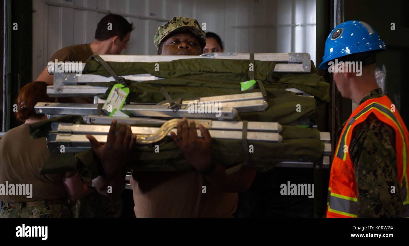 U.S. Navy sailors from various units unloaded cots at the Port of San ...