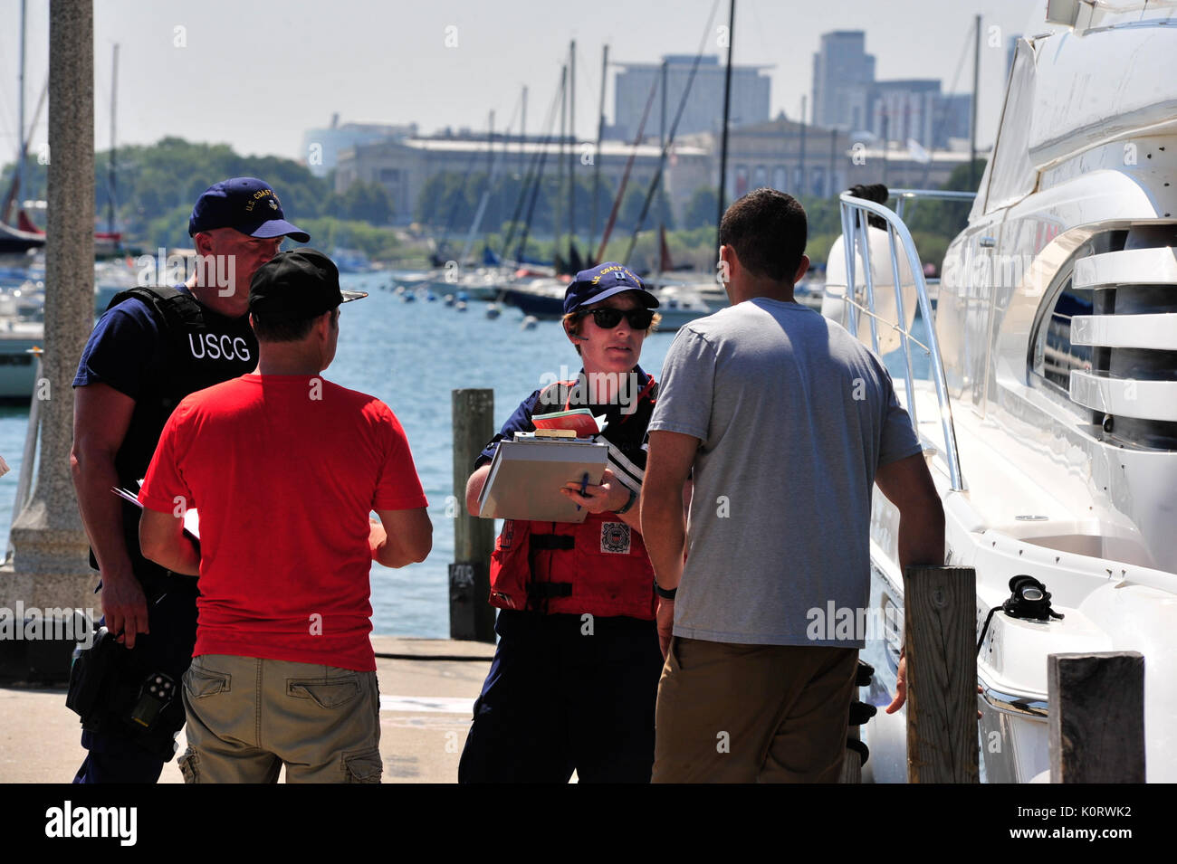 Members of the U.S. Coast Guard verify proper documentation and ...
