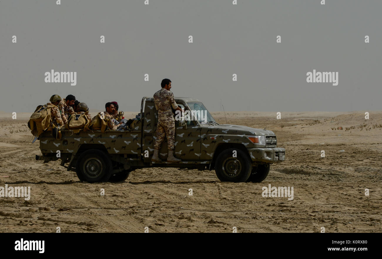 Qatari service members leave the drop zone after conducting a ...