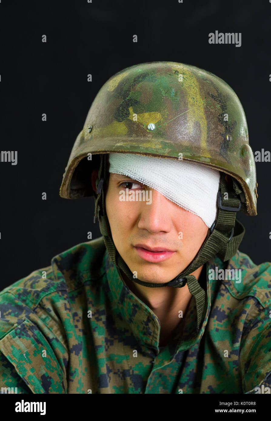 Close up of handsome young soldier wearing uniform suffering from ...