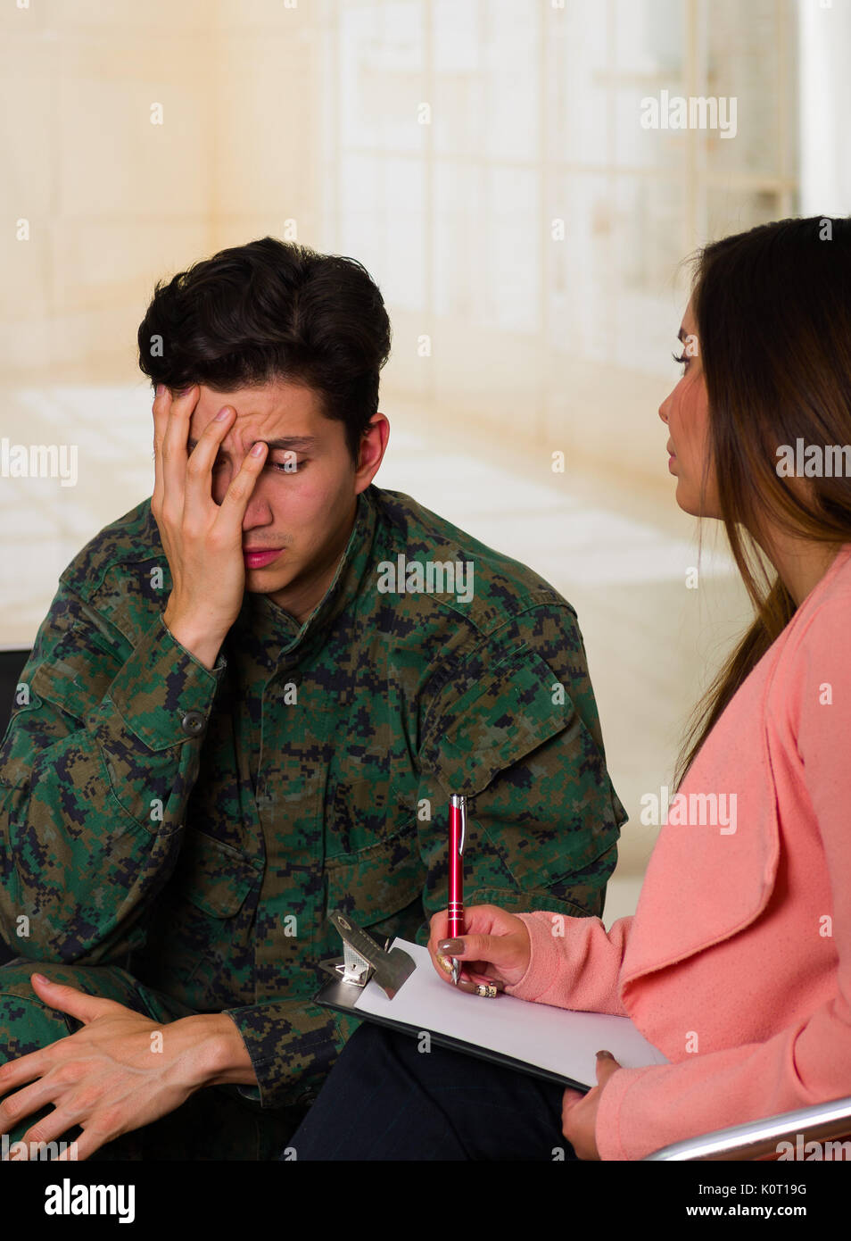 Handsome unhappy young soldier wearing uniform, suffering post ...
