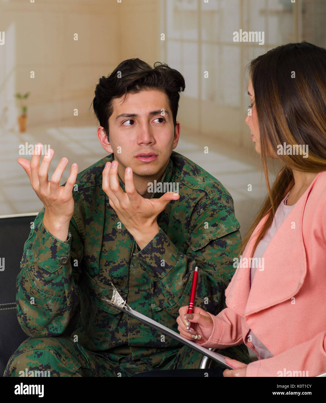 Handsome unhappy young soldier wearing uniform, suffering post ...
