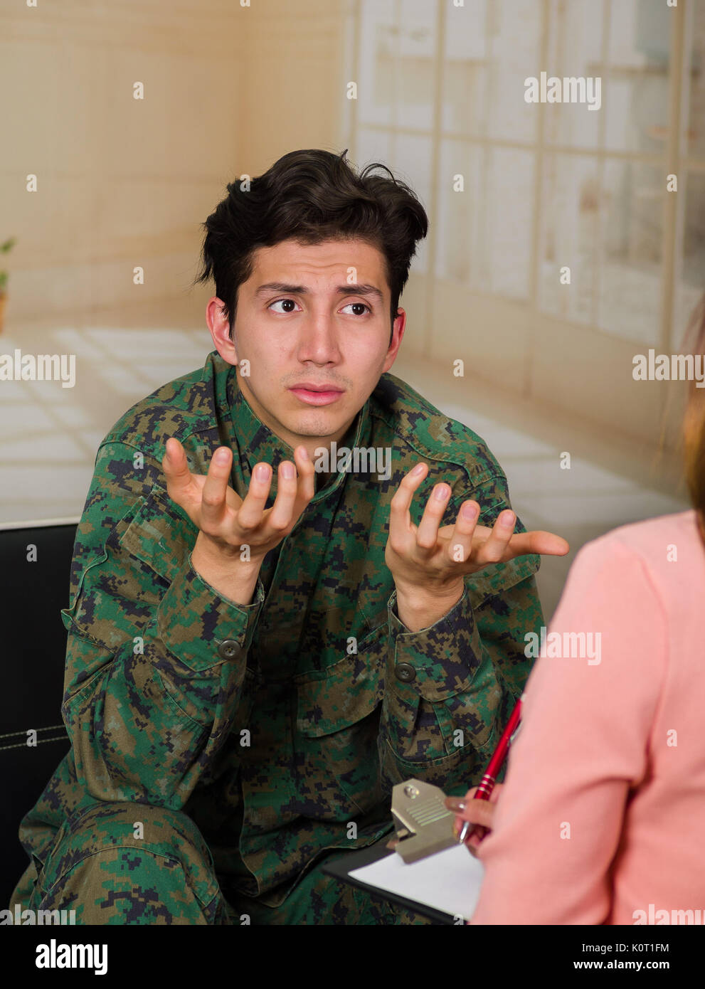 Handsome unhappy young soldier wearing uniform, suffering post ...