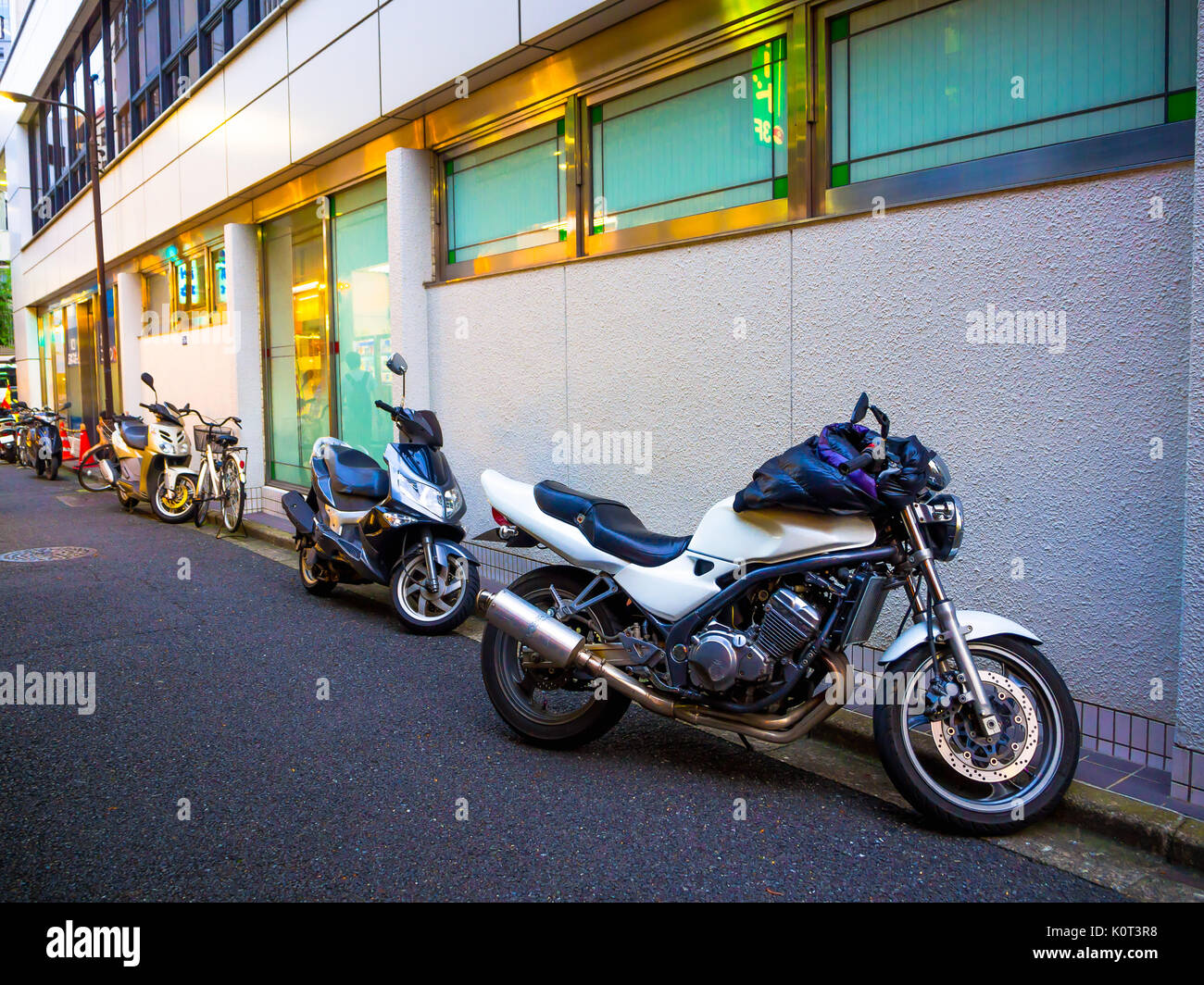 Some motorcycles parked at outdoors of a building, located in Tokyo ...