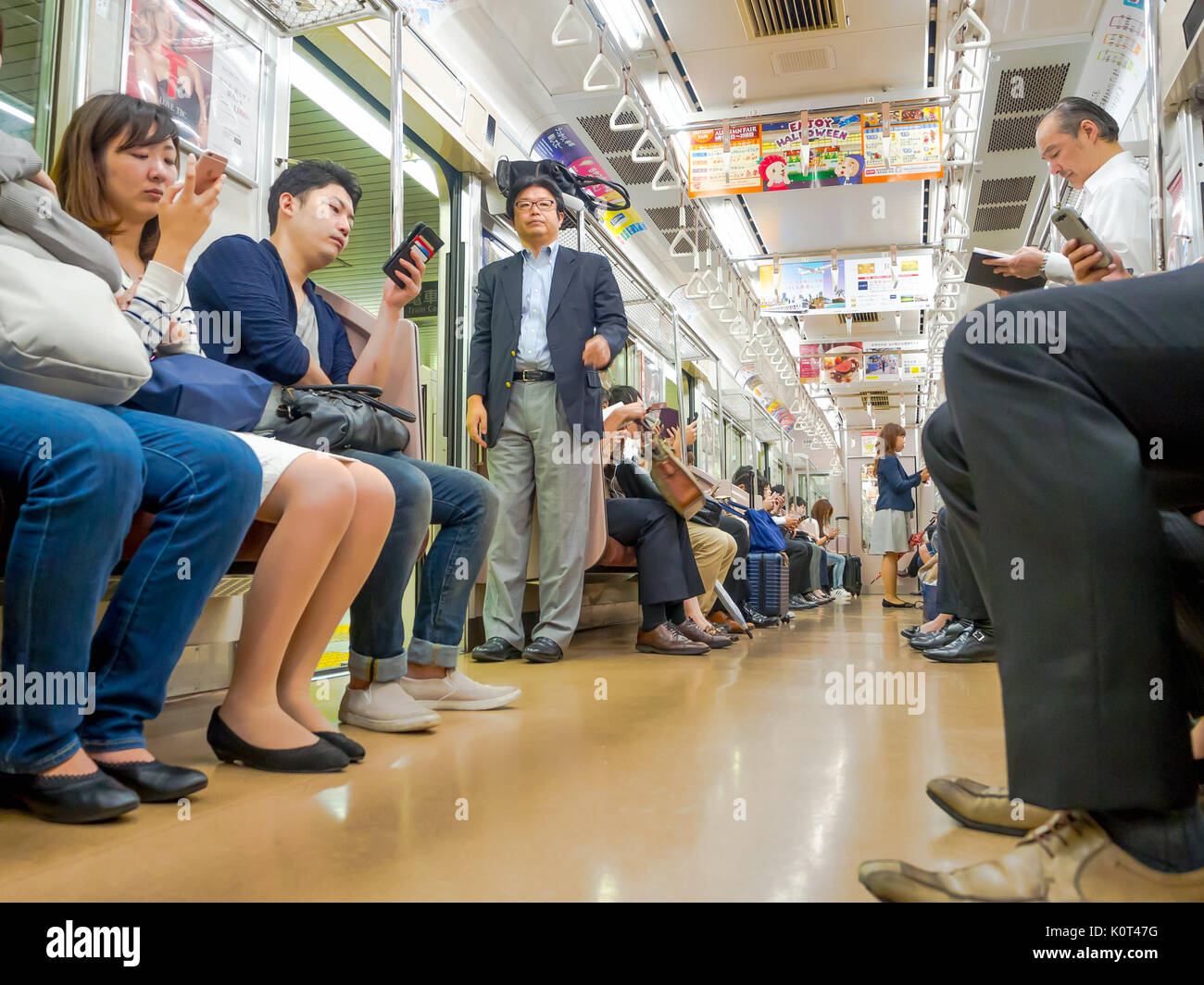 Tokyo, Japan - Jan 2, 2016. People sitting in a Yamanote train in Tokyo ...