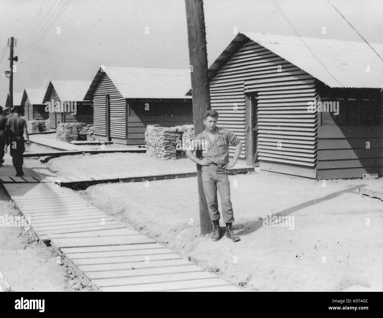 A United States Army serviceman in uniform leaning against a utility ...