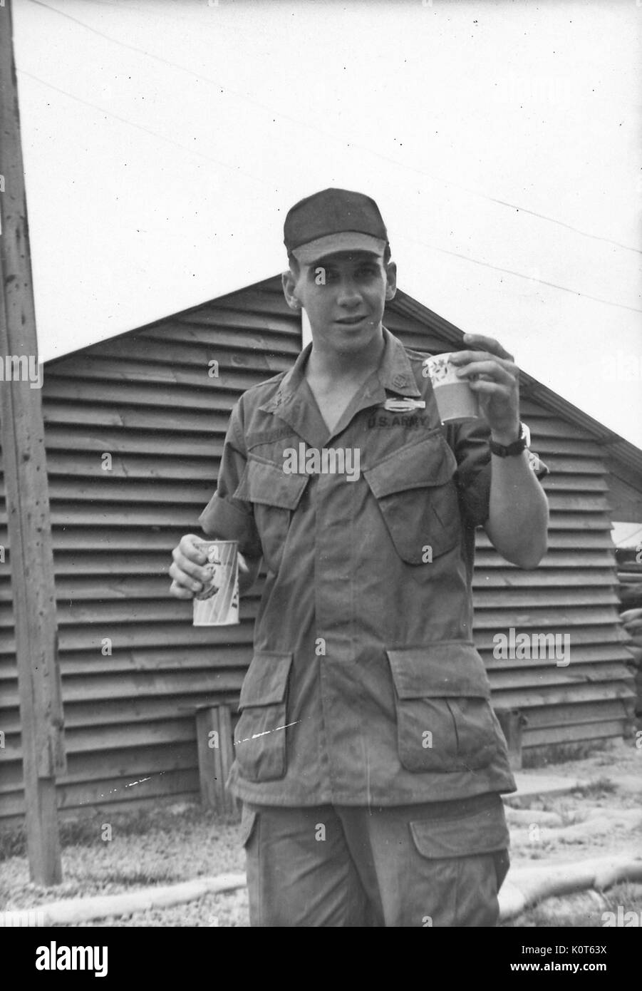 A United States Army serviceman in his uniform, he is carrying a can of ...