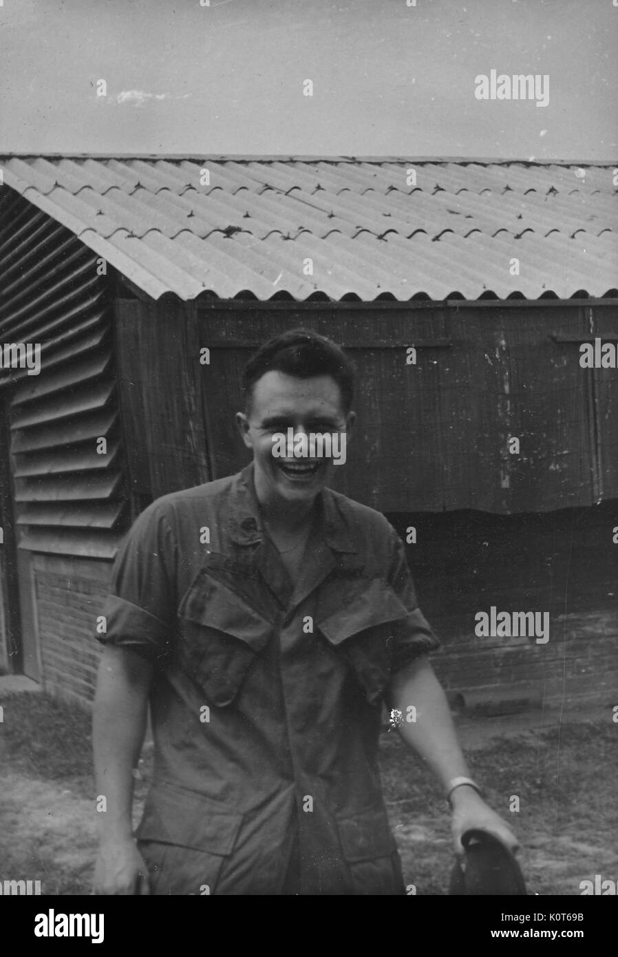 A candid photograph of a soldier laughing while looking directly at the ...