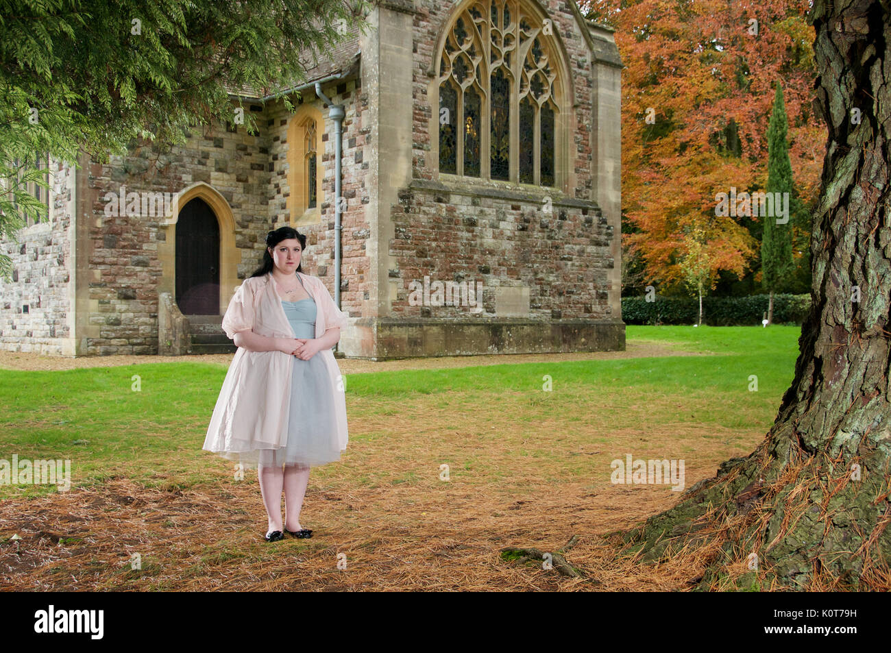 Pretty girl outside a country church wearing a dress Stock Photo - Alamy