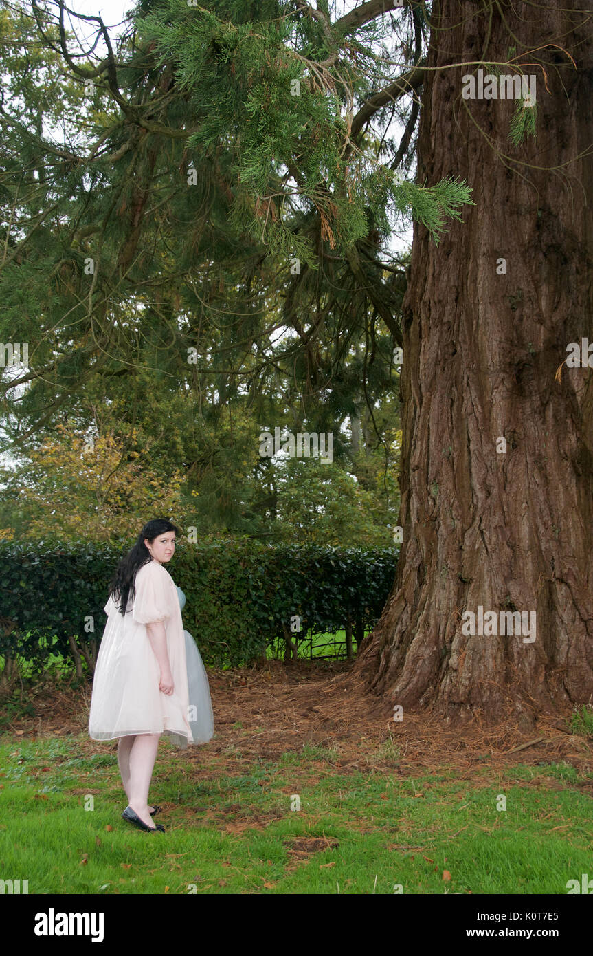 Pretty girl outside a country church wearing a dress Stock Photo - Alamy