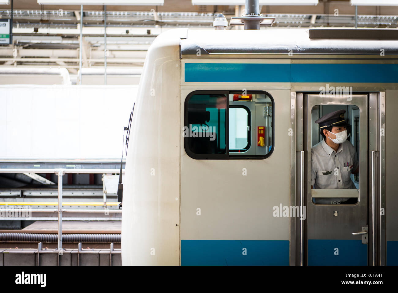 Train conductor looking out the window at a train station Stock Photo ...