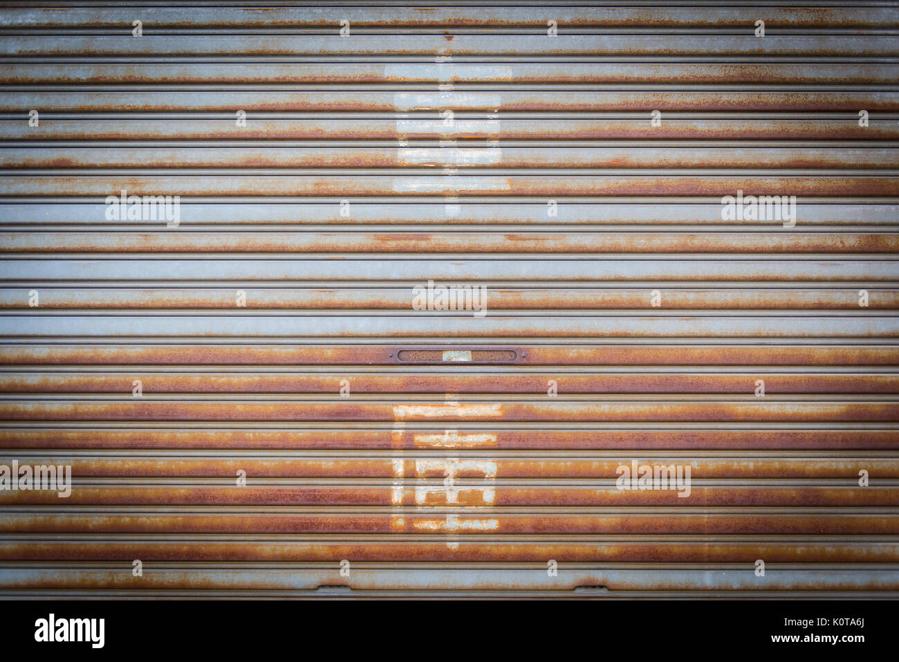 Rusted store shutter door with Kanji writing Stock Photo - Alamy