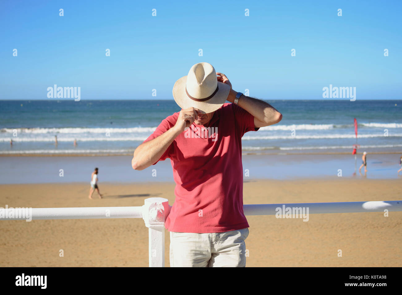 Mature man adjusting his hat Stock Photo - Alamy