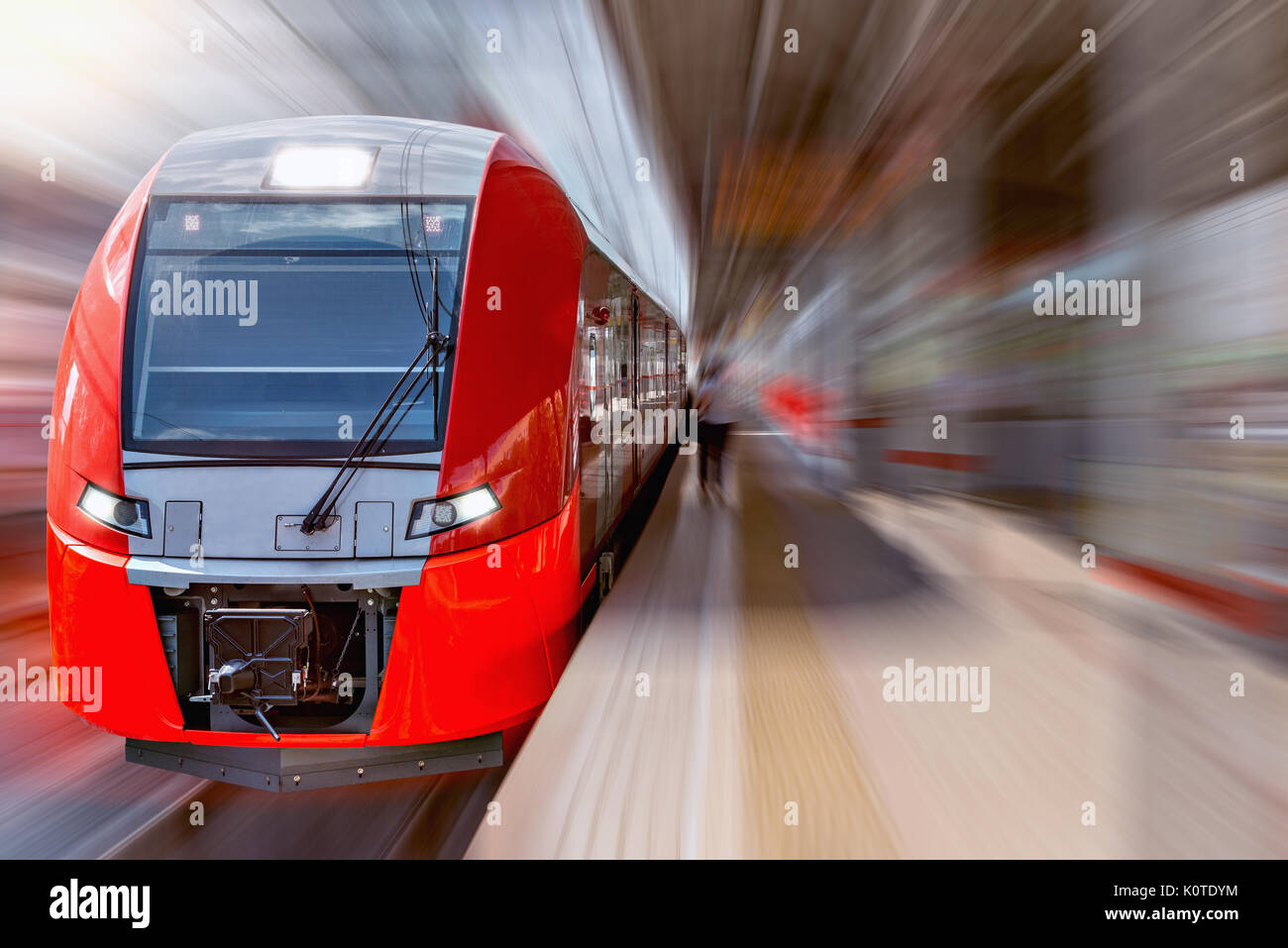 Modern high-speed train moves fast along the platform Stock Photo - Alamy