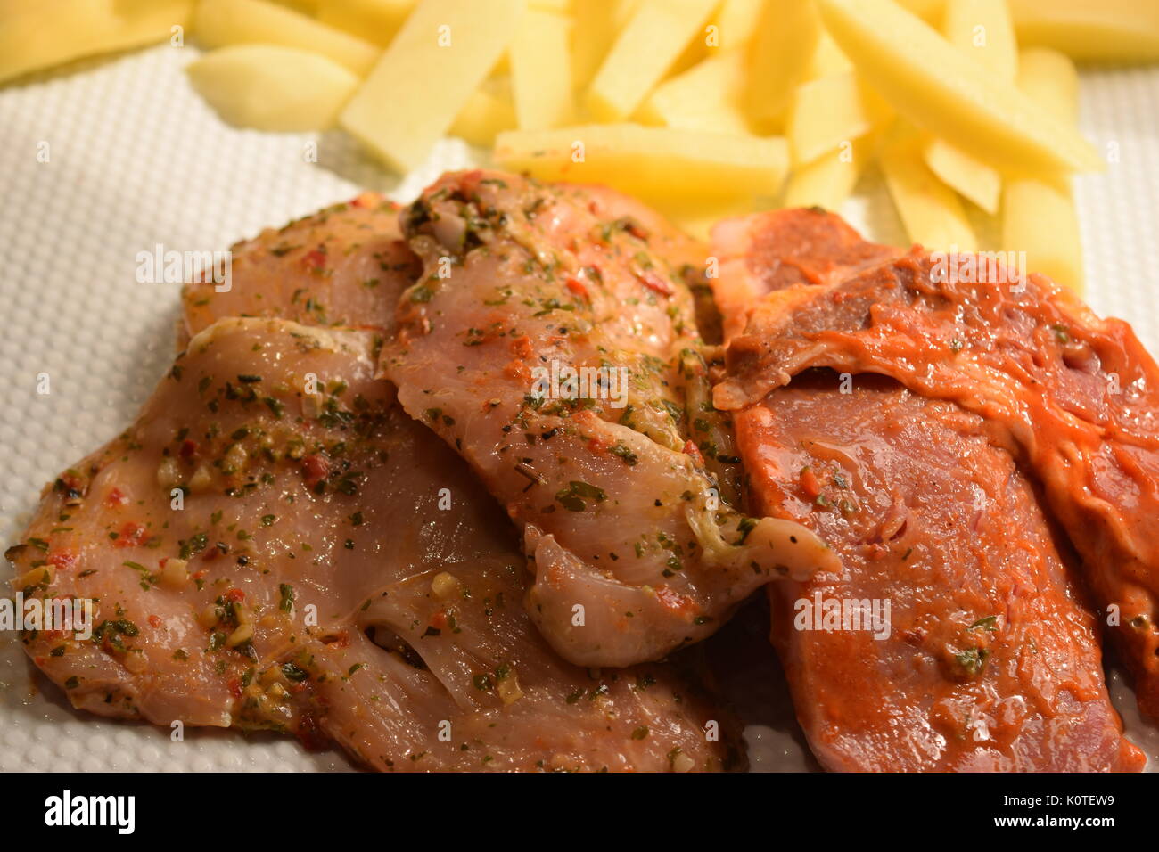 Chicken and pork fillet with chips Stock Photo - Alamy