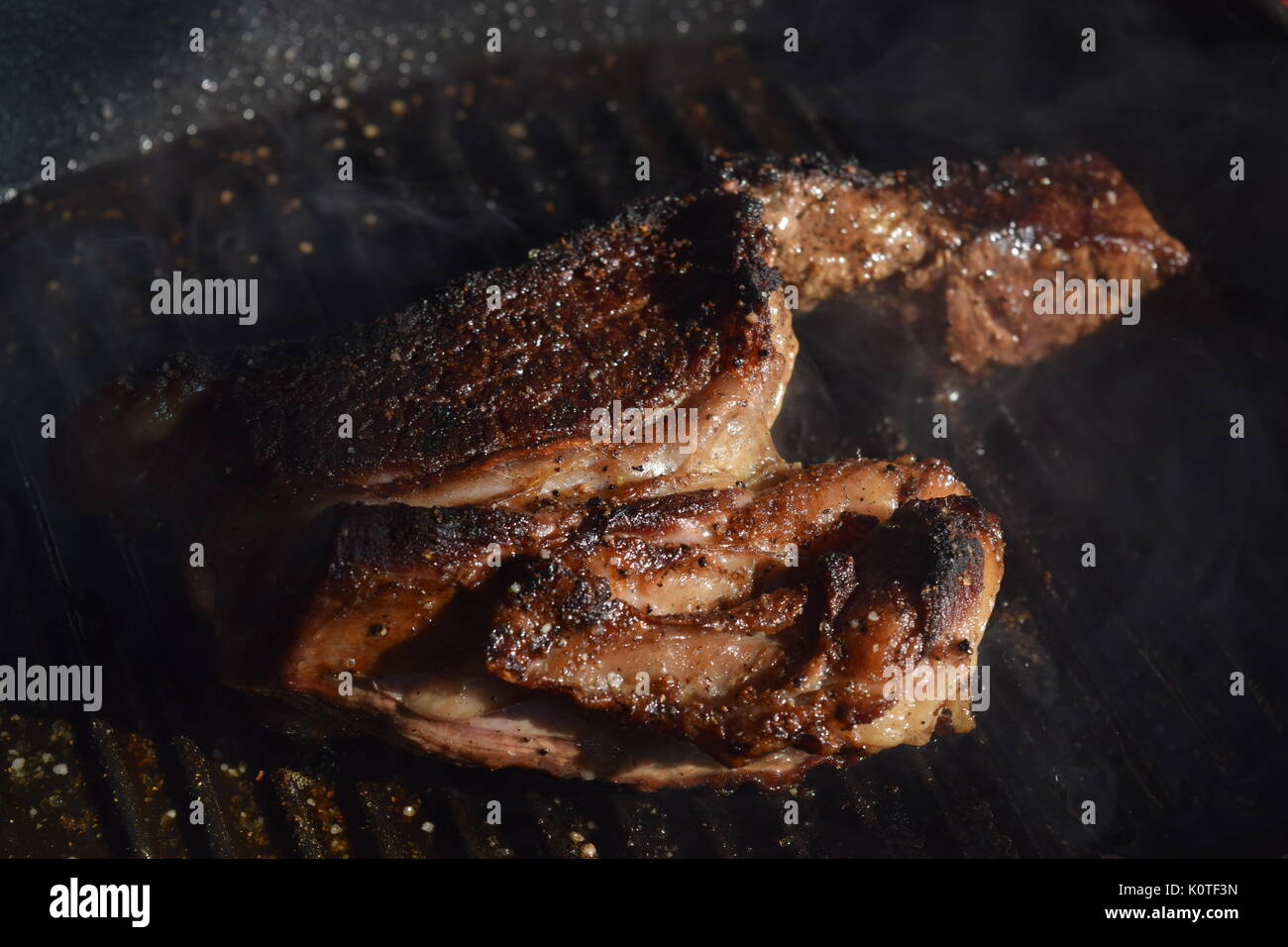 Meat cooking on a grill Stock Photo - Alamy