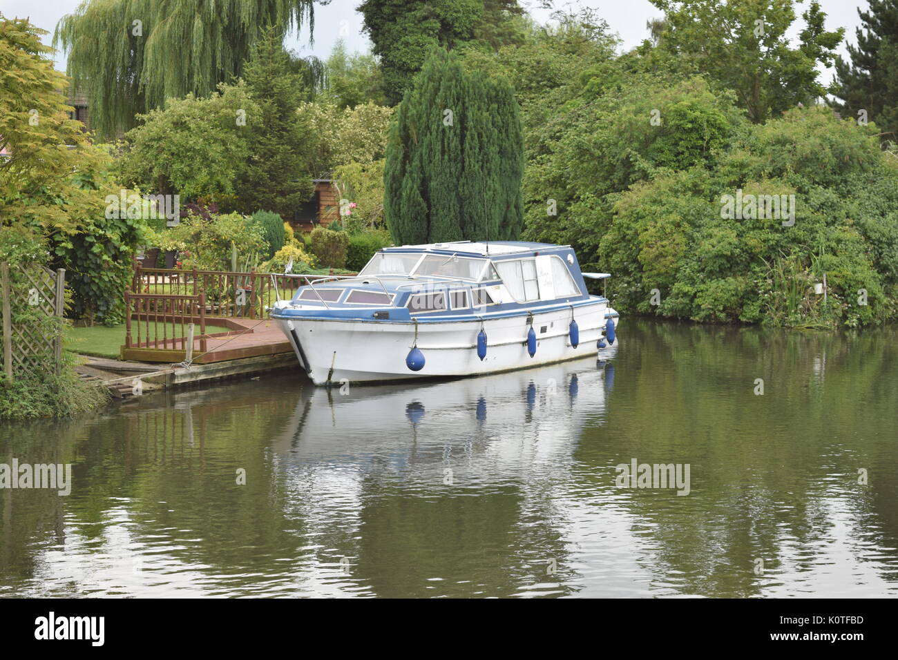 Long flowing canal with trees and houses Stock Photo - Alamy