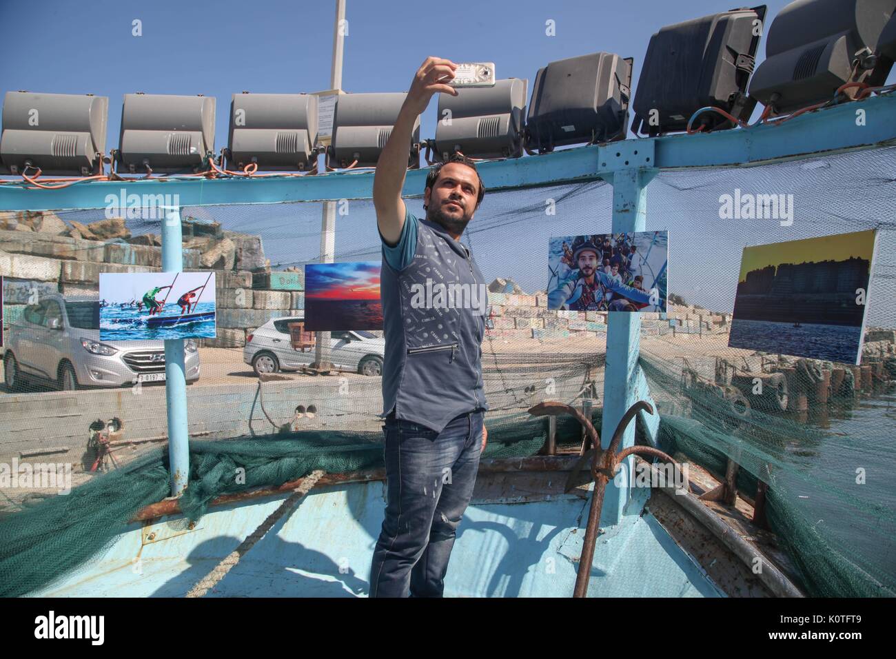 Palestinians attend a photo gallery on fishing boat, in Gaza seaport ...