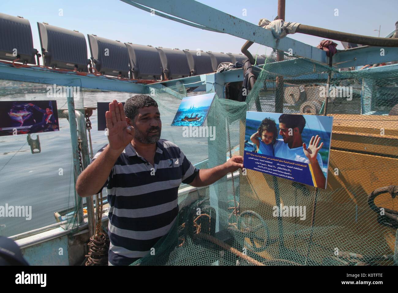 Palestinians attend a photo gallery on fishing boat, in Gaza seaport ...