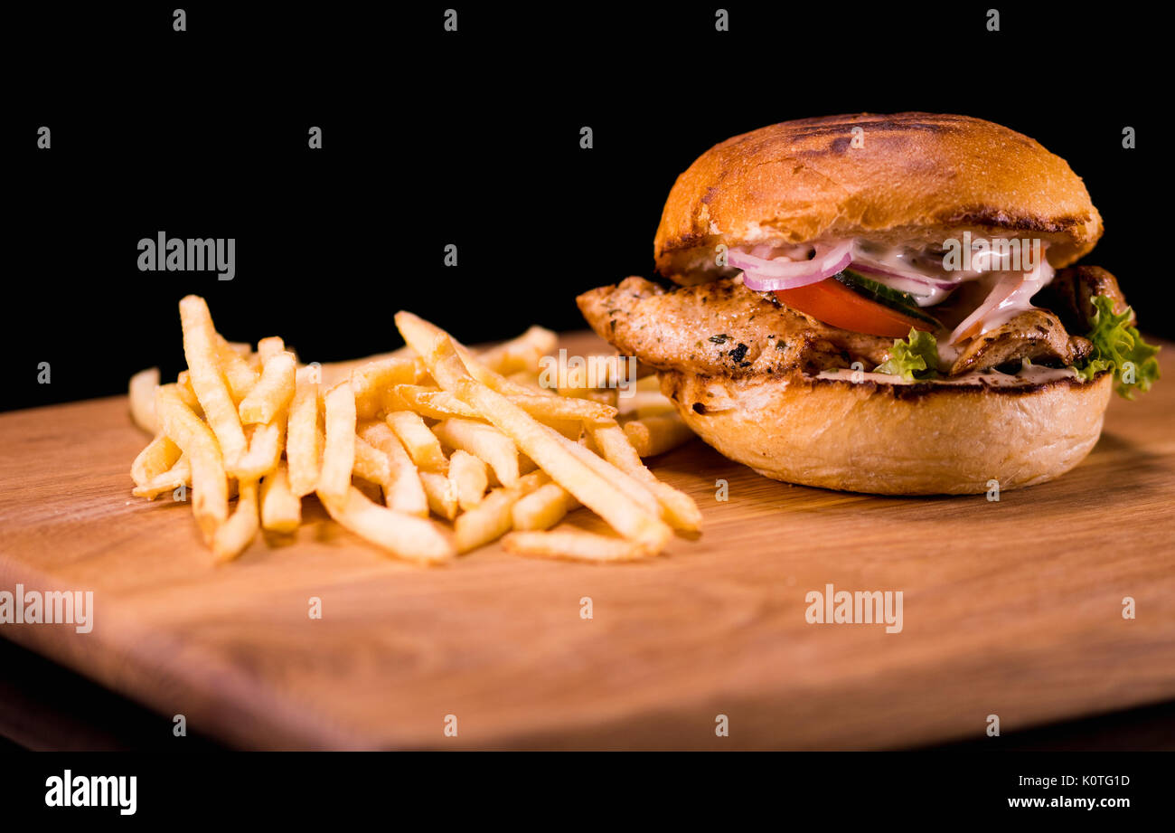 Fresh grilled Chicken Burger with fries Stock Photo - Alamy
