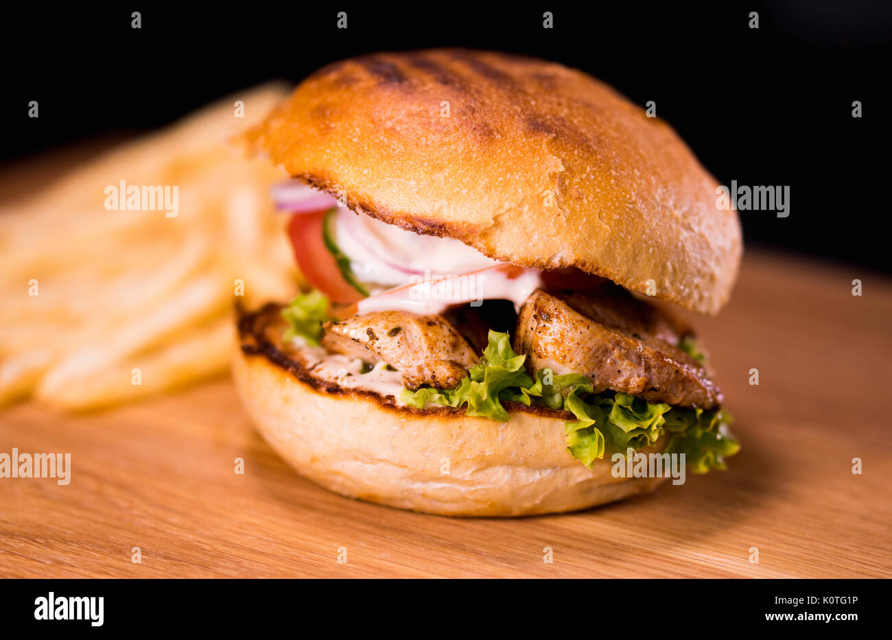 Fresh grilled Chicken Burger with fries Stock Photo - Alamy