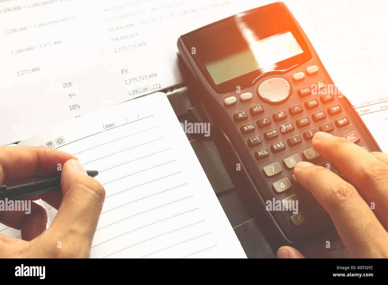 Close-up of Human accountant making calculations while sitting at desk ...