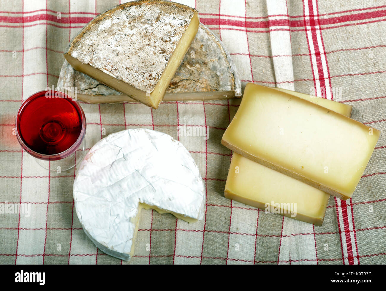 Different french cheeses with a glass of red wine Stock Photo - Alamy