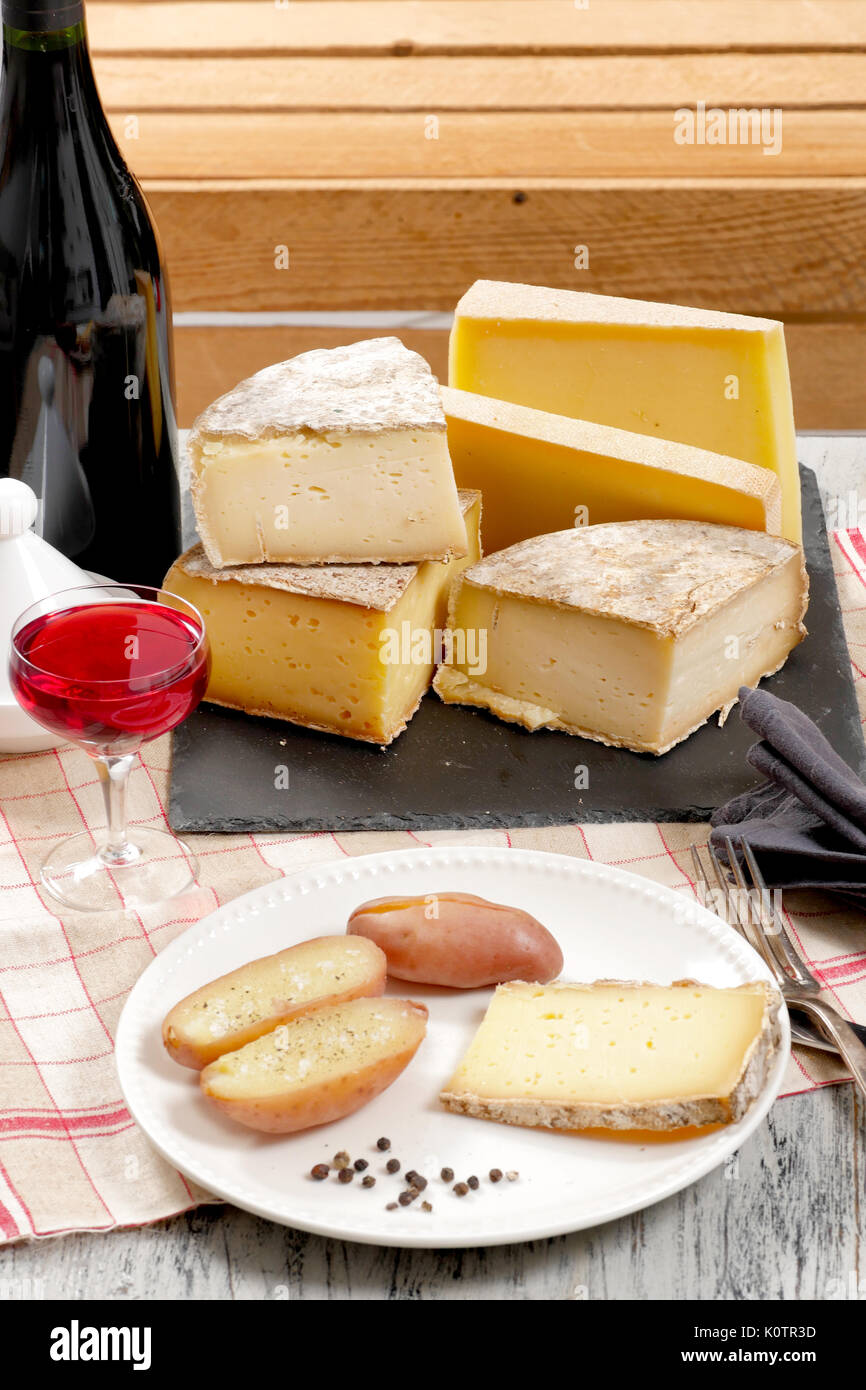 Different french cheeses with a glass of red wine Stock Photo - Alamy