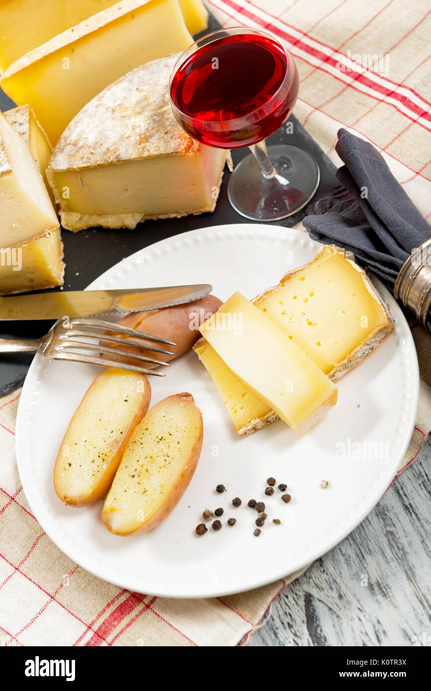 Different french cheeses with a glass of red wine Stock Photo - Alamy