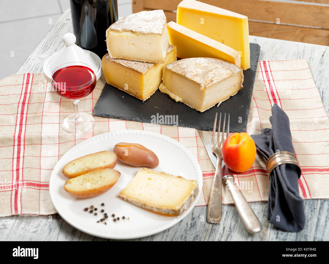 Different french cheeses with a glass of red wine Stock Photo - Alamy