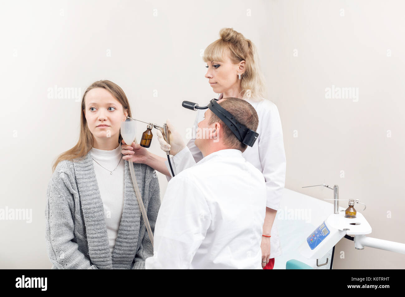 ENT physician looking into patient's ear with an instrument. private ...